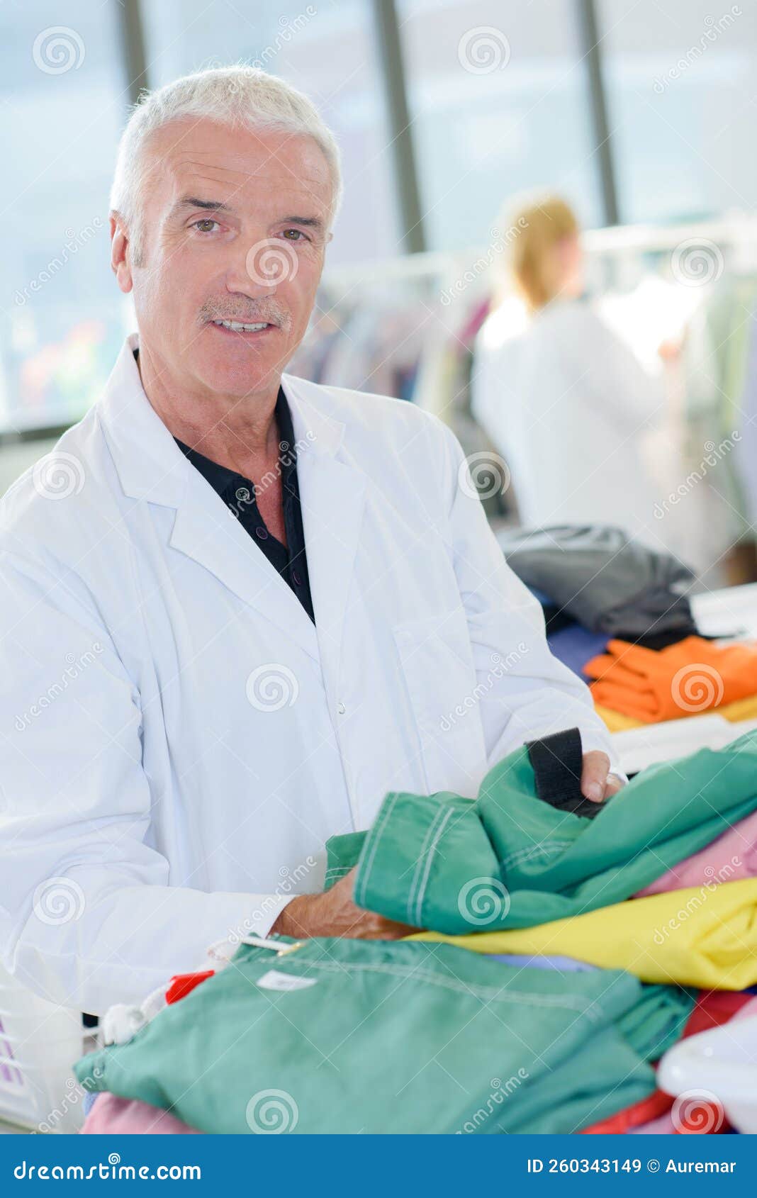 Mature Worker Sorting Out Clothes Stock Image - Image of hotel, duty ...