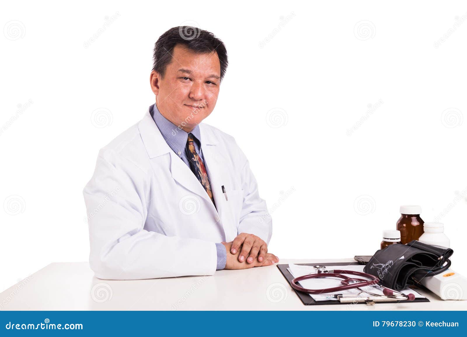 Matured Asian Medical Practitioner Seated Behind Desk Stock Photo ...