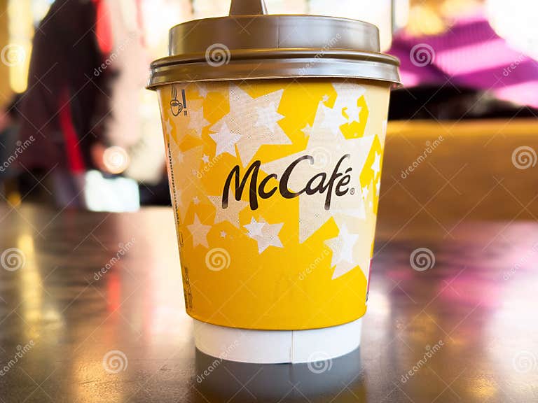 Mccafe Coffee Cup with Star Design on Reflective Table Surface ...