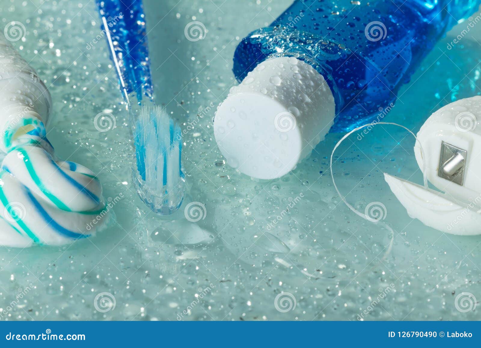 Means for Oral Care and Teeth Care on Light Background in Water Drops ...