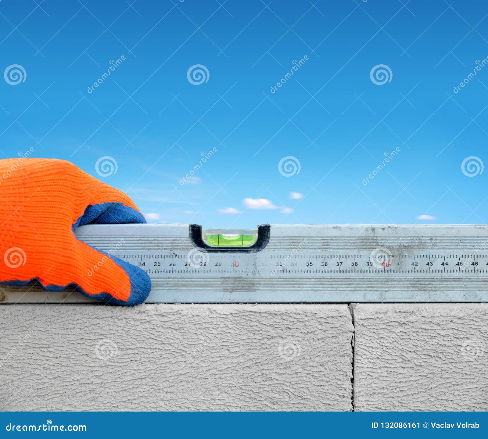 A Man Measures On The Wall With A Ruler, A Tape Measure, A Level, Marks ...