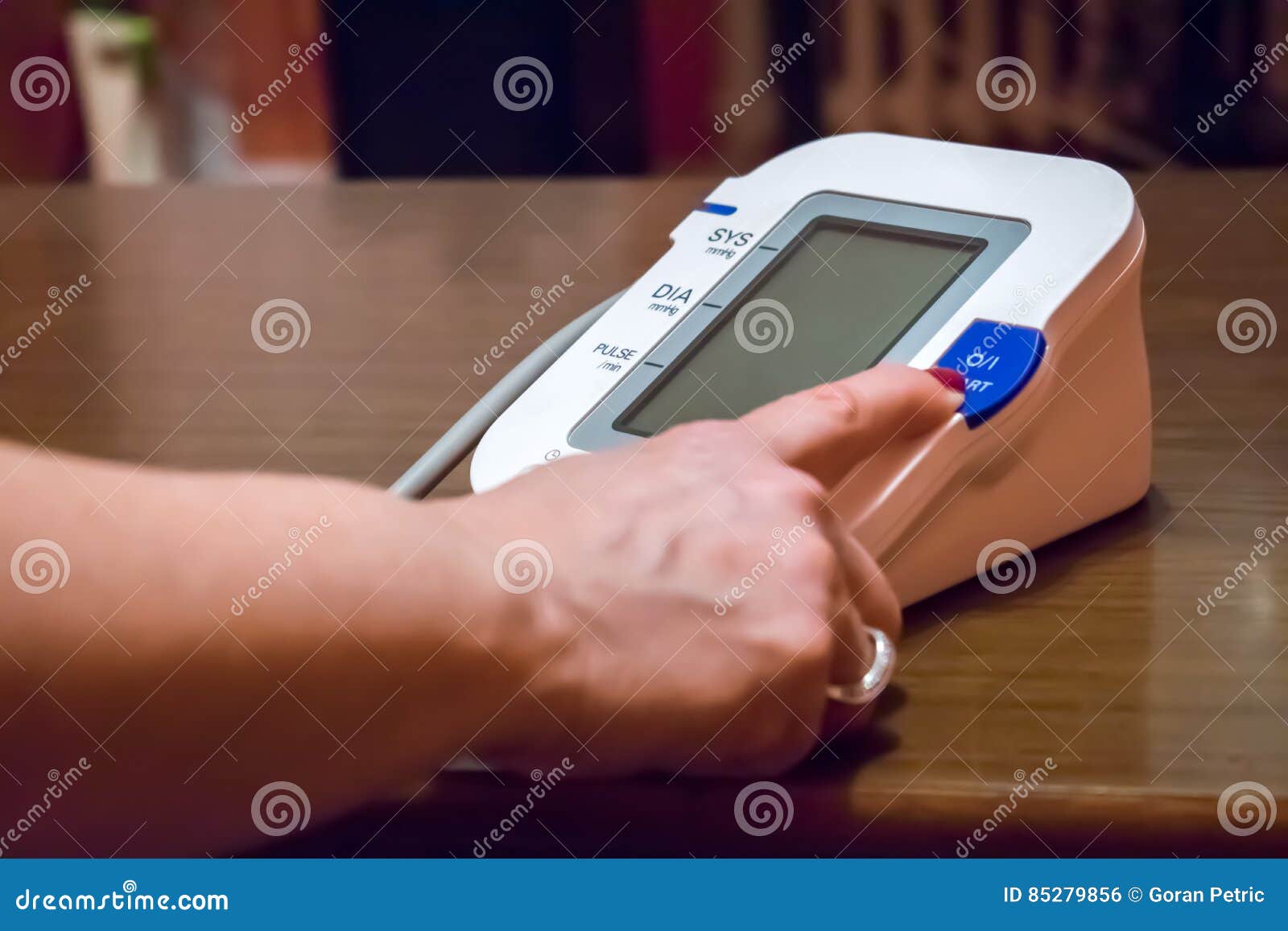 Measuring Blood Pressure and Female Finger Presses the Start Button ...