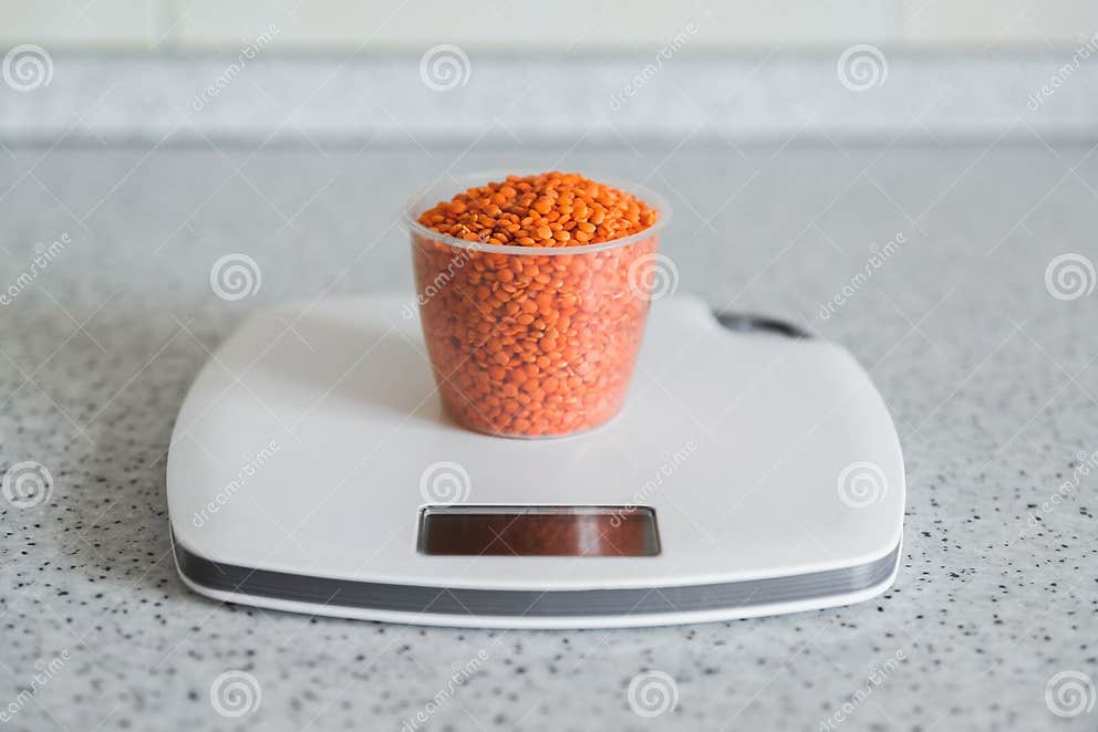 Measuring Cup with Red Lentil on Digital Kitchen Scales on Kitchen ...
