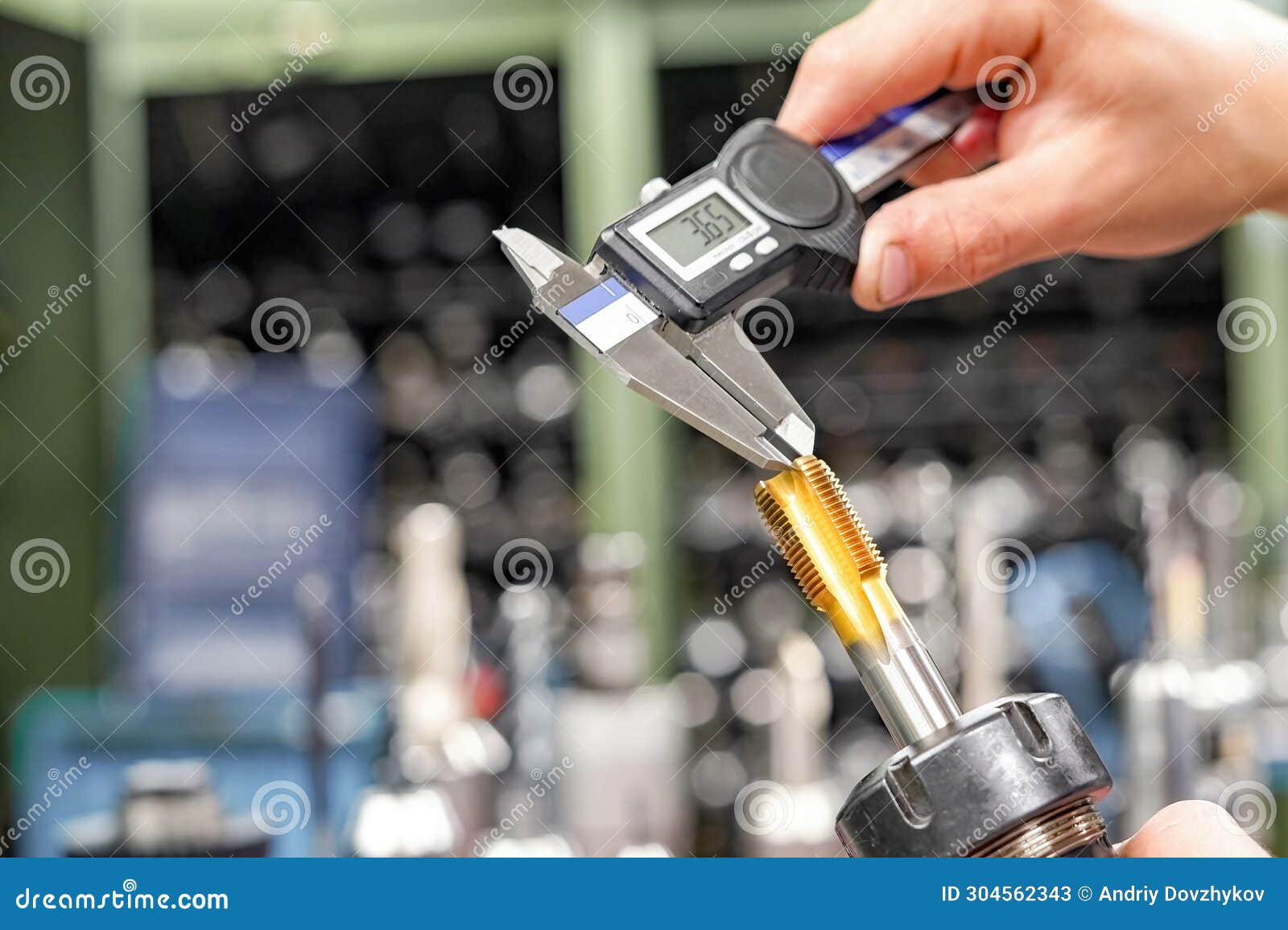 Measuring a Cutting Tool with a Caliper for a CNC Machine Tool. Stock ...