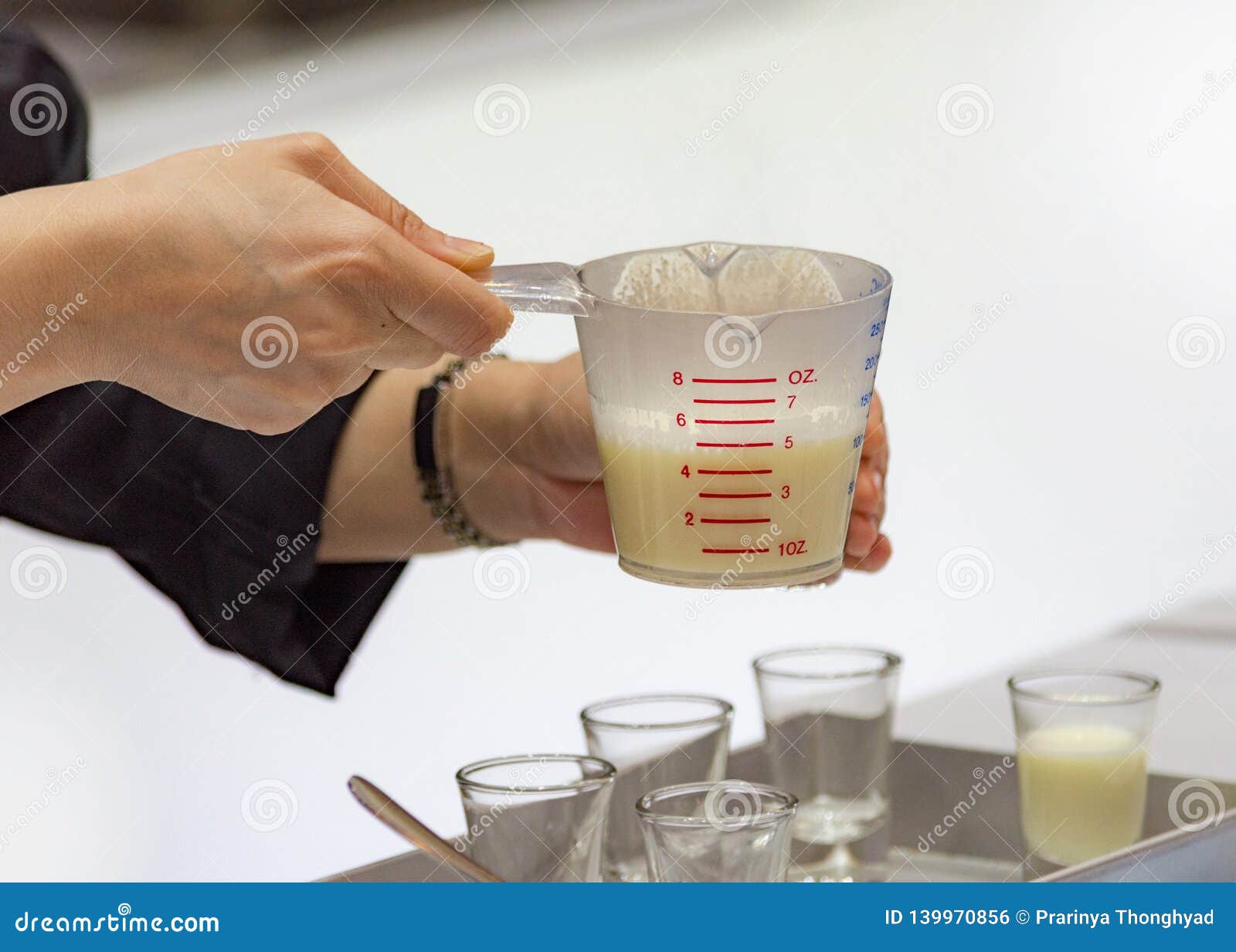 Measuring Out Milk in a Measuring Jug for Cooking or Test Stock Photo ...