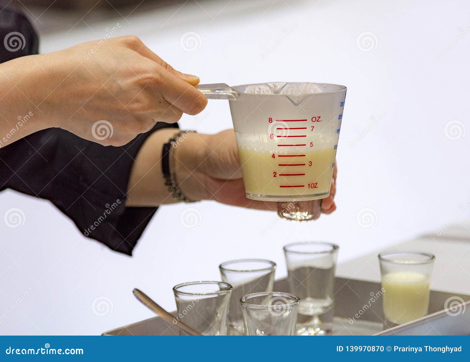 Measuring Out Milk in a Measuring Jug for Cooking or Test Stock Photo ...