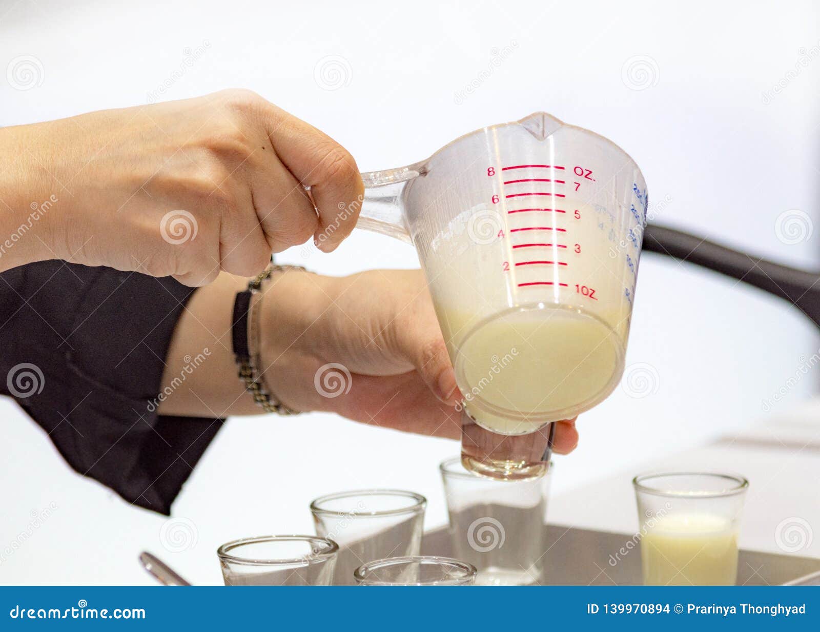Measuring Out Milk in a Measuring Jug for Cooking or Test Stock Photo ...