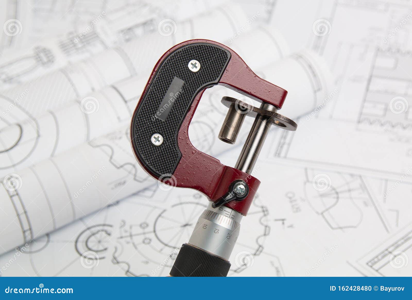 Measuring a Part with a Micrometer in the Background Stock Photo ...
