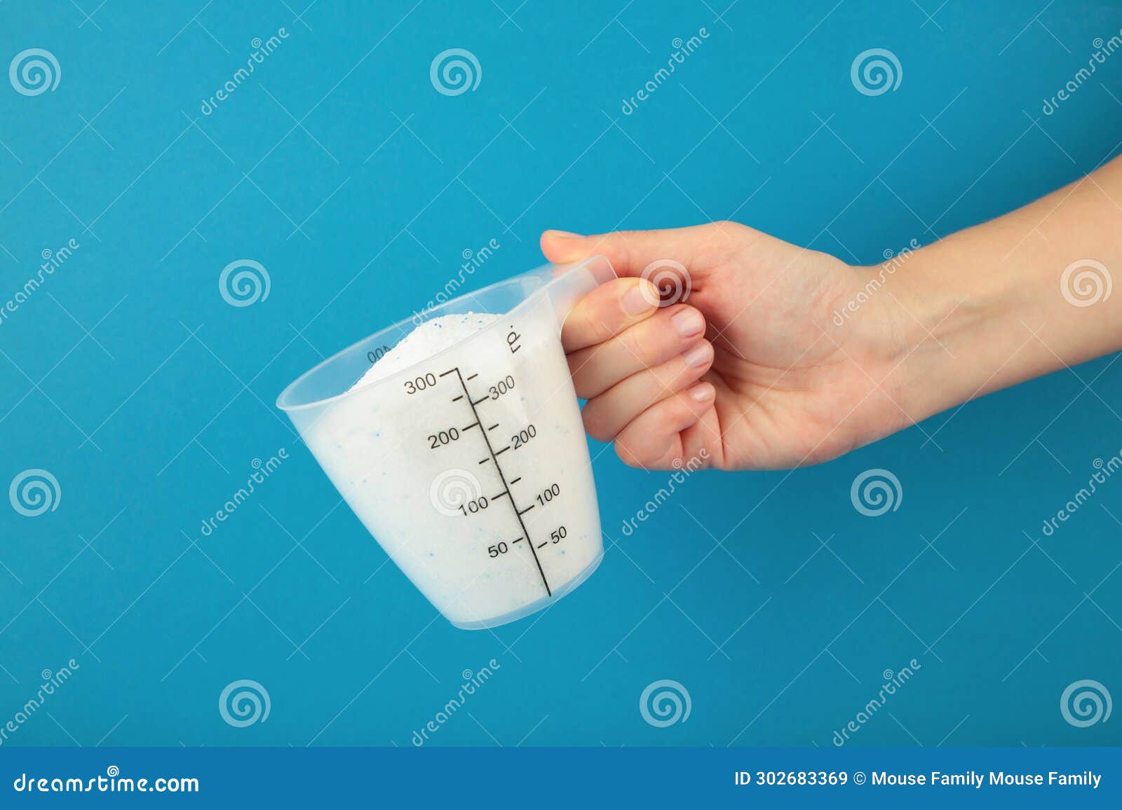 Measuring Spoon with Washing Powder in Hand on Blue Background Stock ...