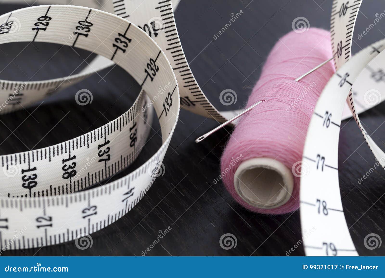 Measuring Tape and Sewing Needle in a Spool of Thread Stock Image ...