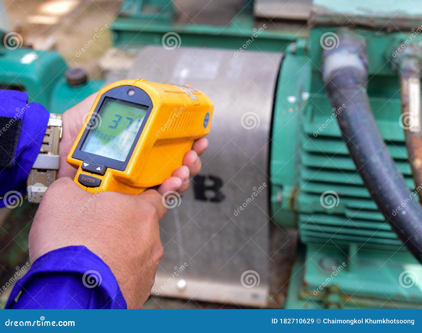 Measuring the Temperature of Motor with Infrared Thermometer Stock ...