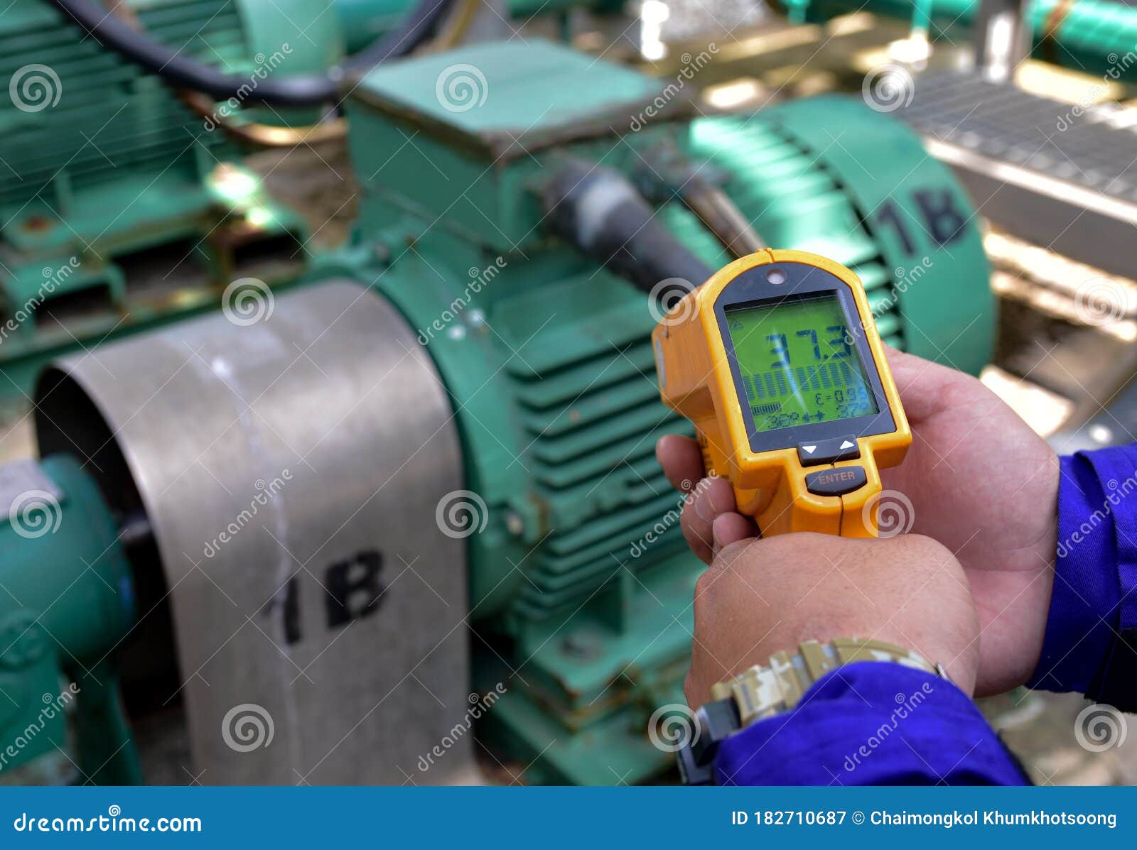 Measuring the Temperature of Motor with Infrared Thermometer Stock ...