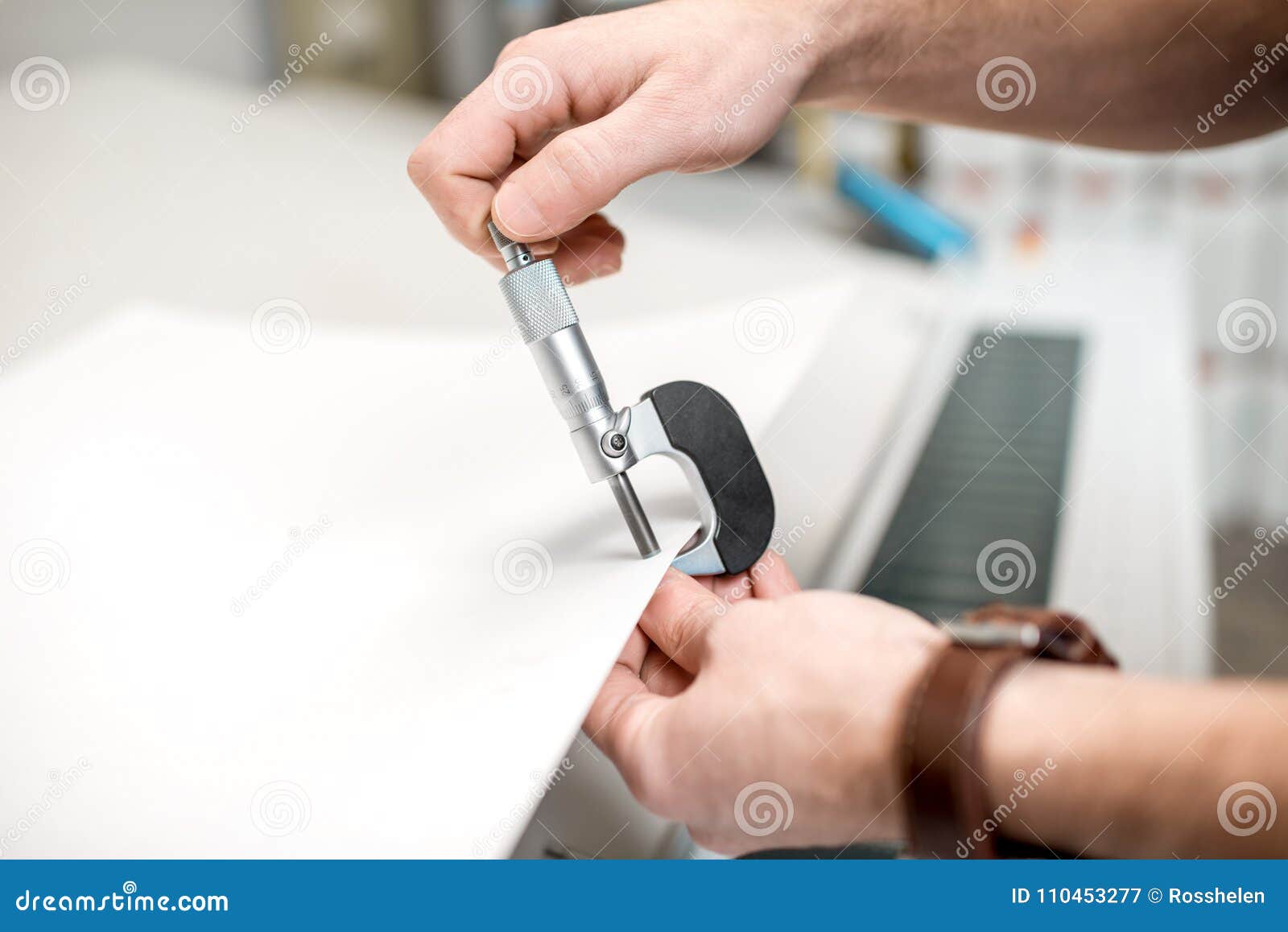 Measuring Thickness of the Paper Sheet with Micrometer Stock Image ...