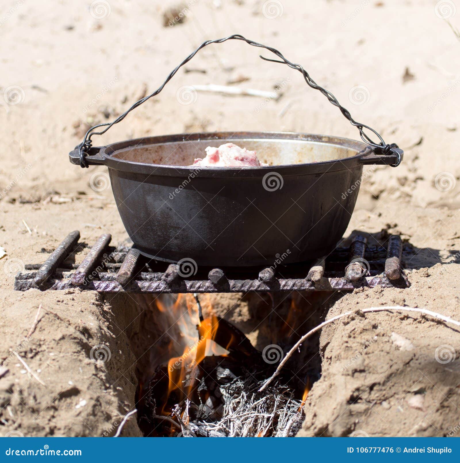 Meat in a cauldron on fire stock photo. Image of outdoors - 106777476