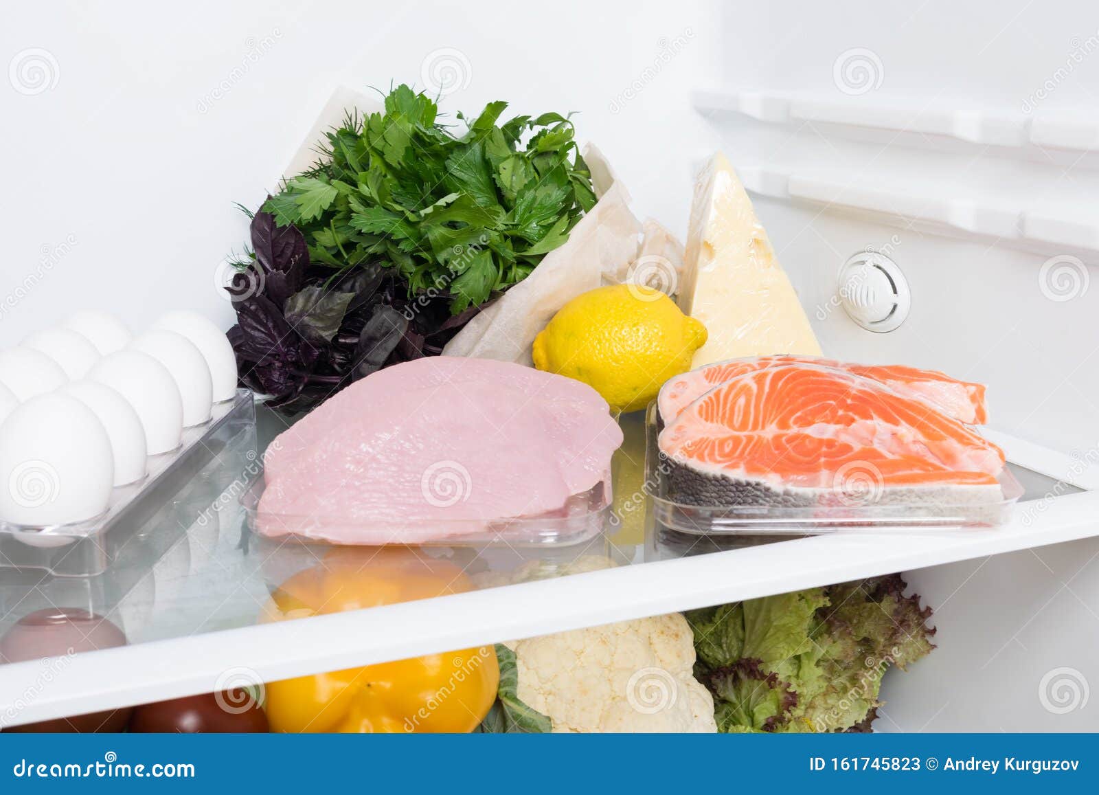 Meat, Fish and Chicken with Greens on a Shelf in the Refrigerator Stock ...