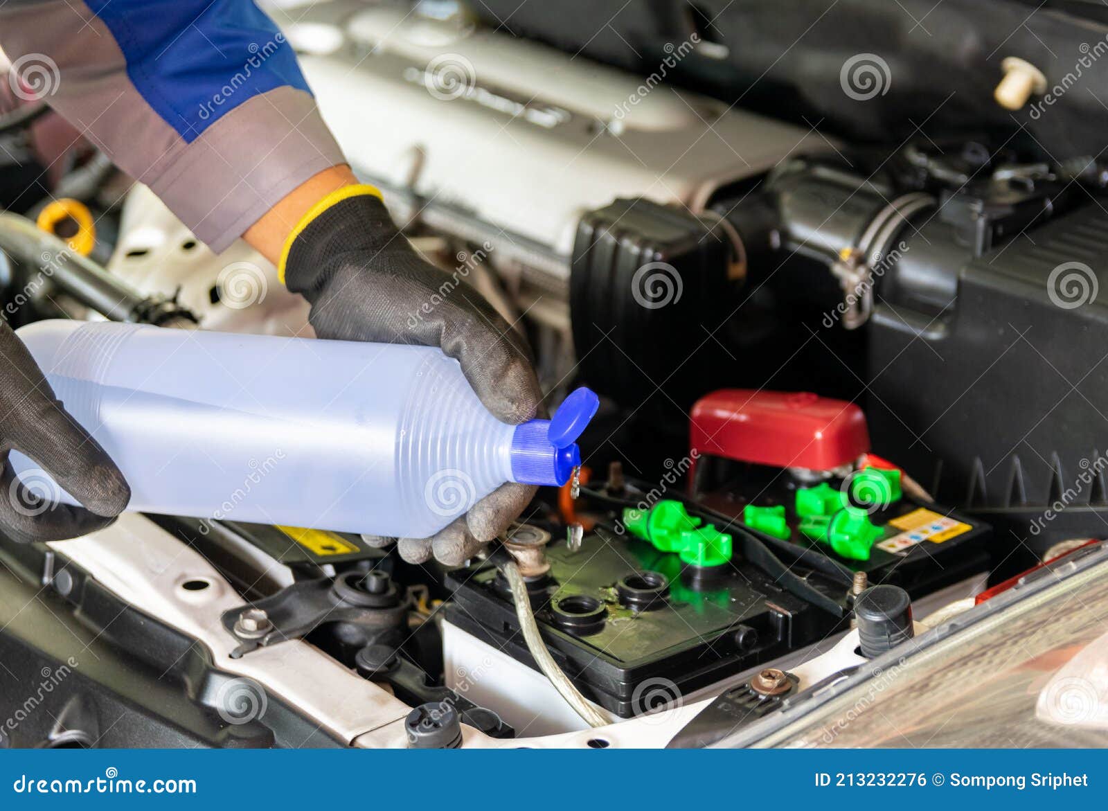 The Mechanic Adds Distilled Water Check the Car Battery Stock Photo ...