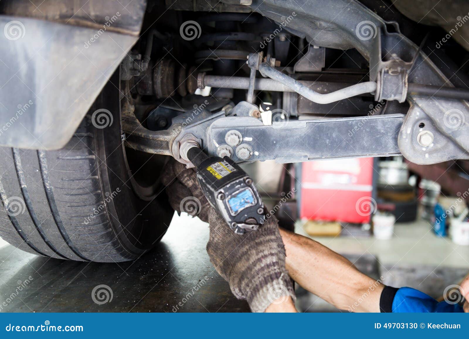 Mechanic Adjusting the Chamber Area during Wheel Alignment Process ...