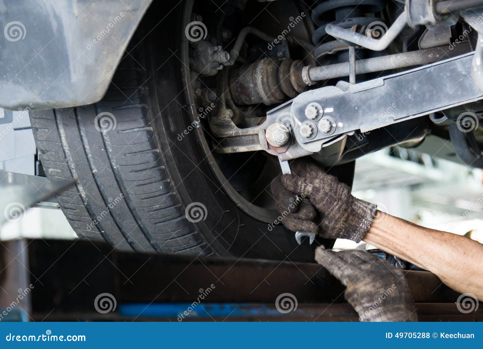 Mechanic Adjusting The Chamber Area During Wheel Alignment Process ...