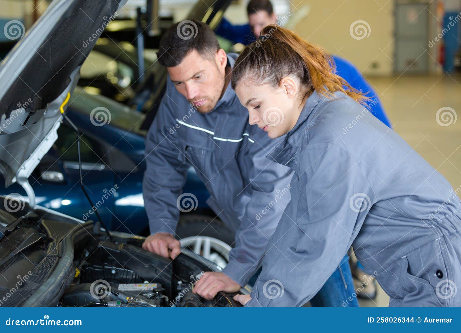 Mechanic and Apprentice Looking at Cars Engine Stock Photo - Image of ...