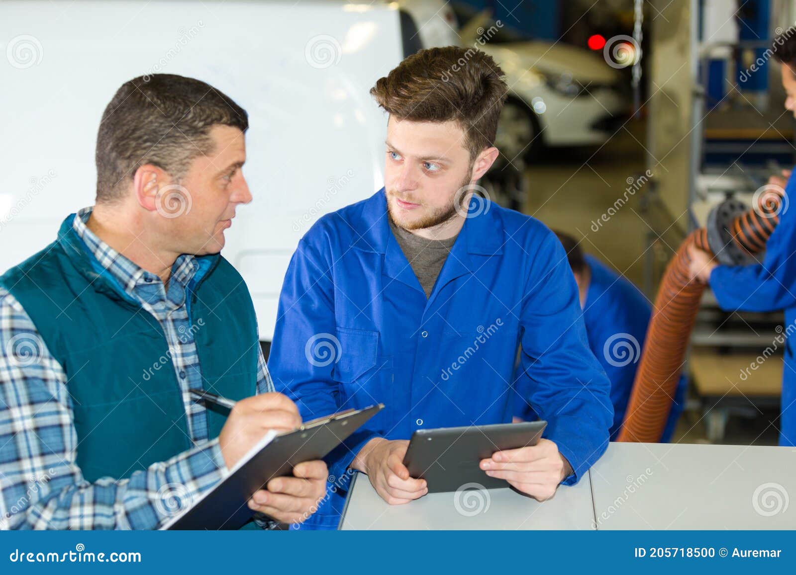Mechanic and Apprentice at Work Stock Photo - Image of teaching, male ...