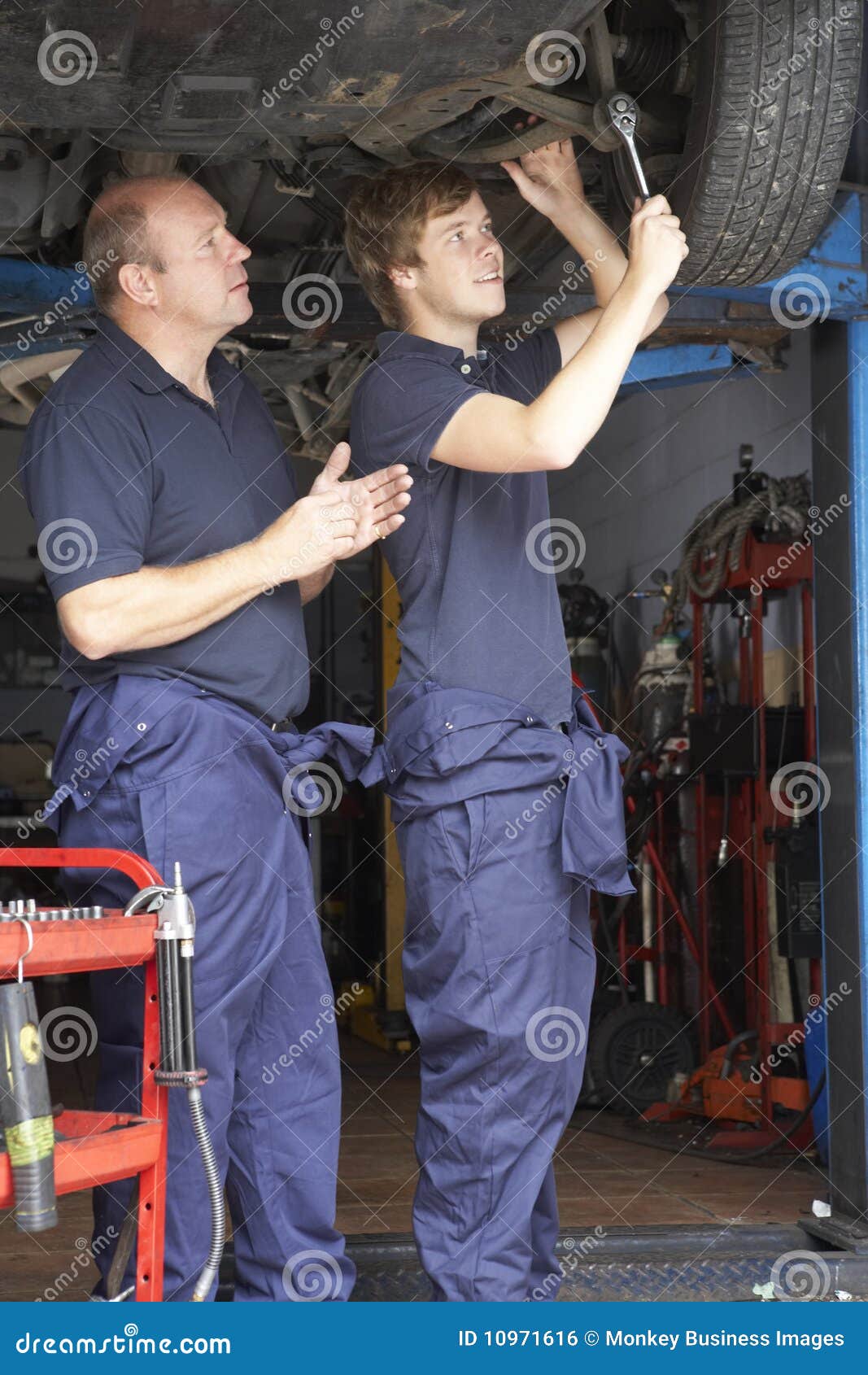 Mechanic and Apprentice Working on Car Stock Photo - Image of skill ...