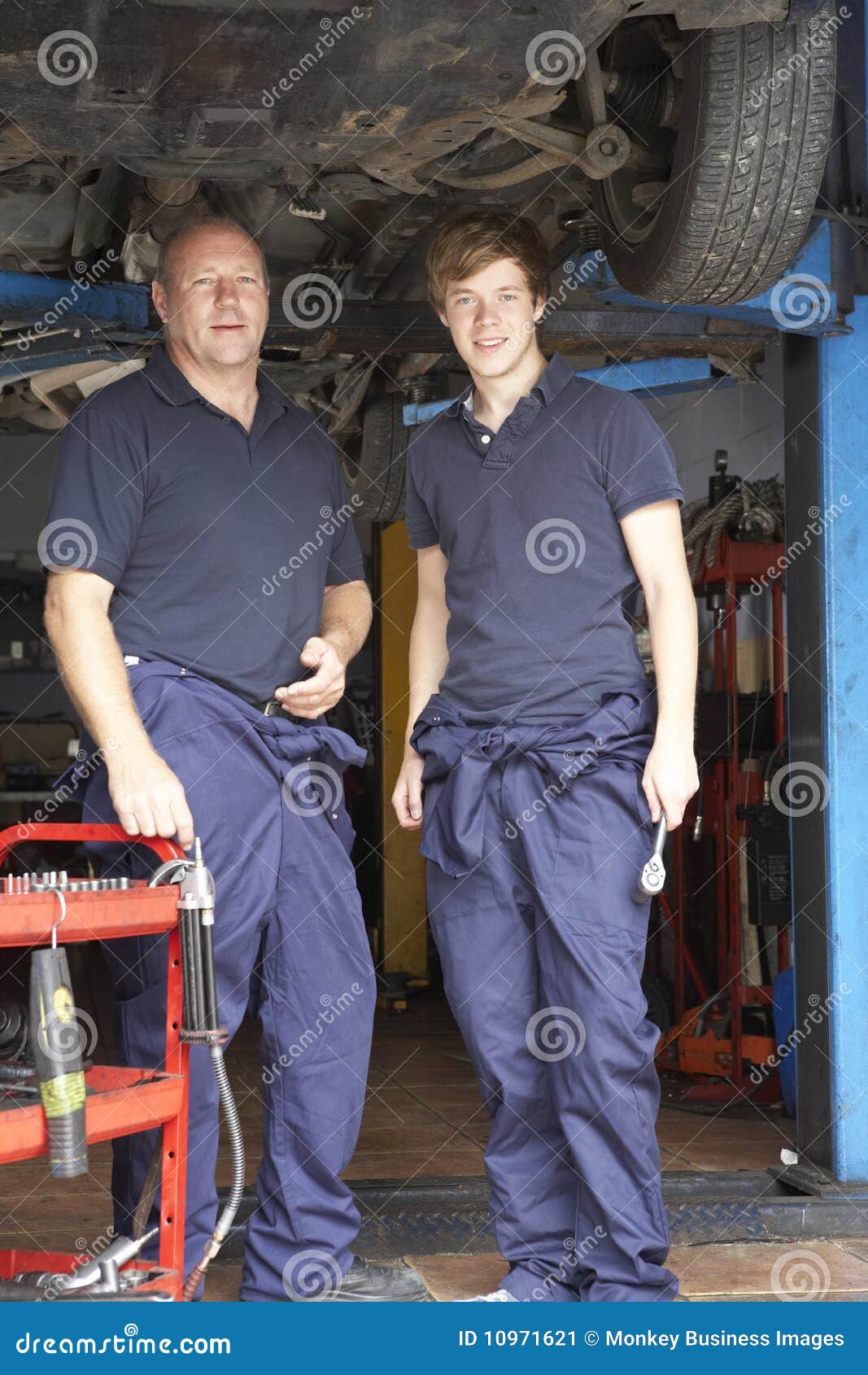 Mechanic and Apprentice Working on Car Stock Image - Image of employed ...