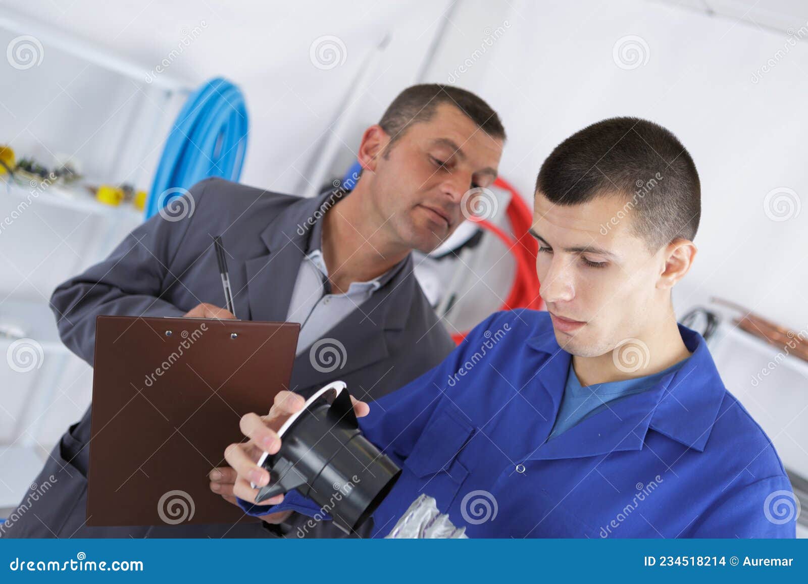 Mechanic and Apprentice Working on Car with Computer Stock Photo ...