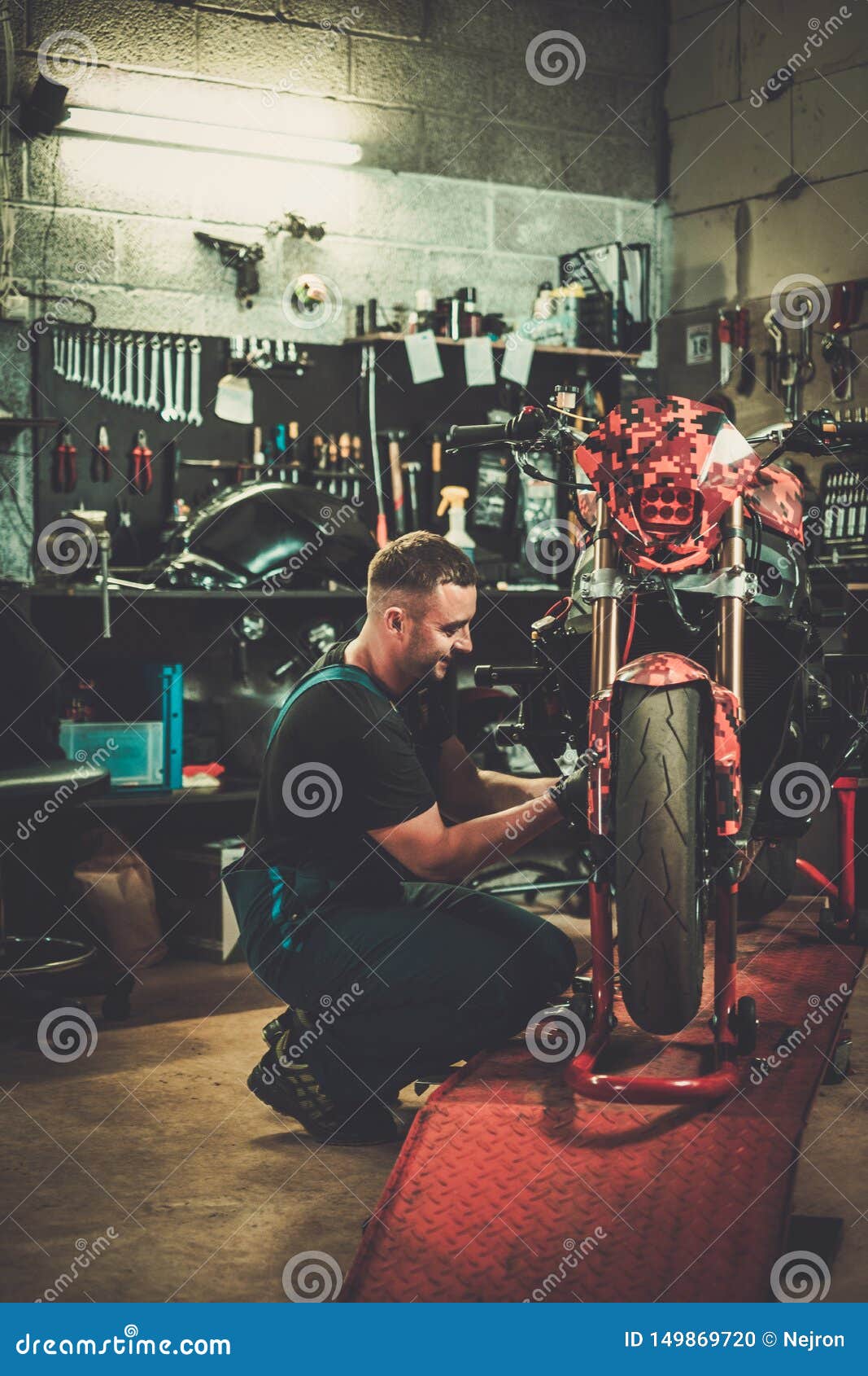Mechanic Arepairing a Motorcycle in a Workshop Stock Photo - Image of ...