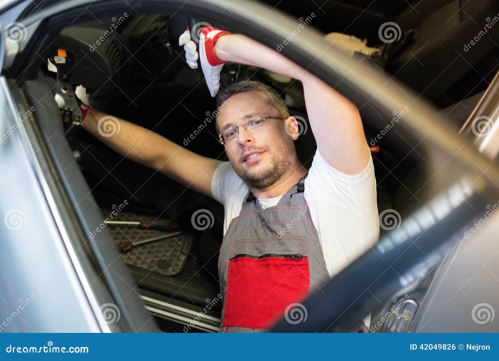 Mechanic in a car interior stock photo. Image of official - 42049826