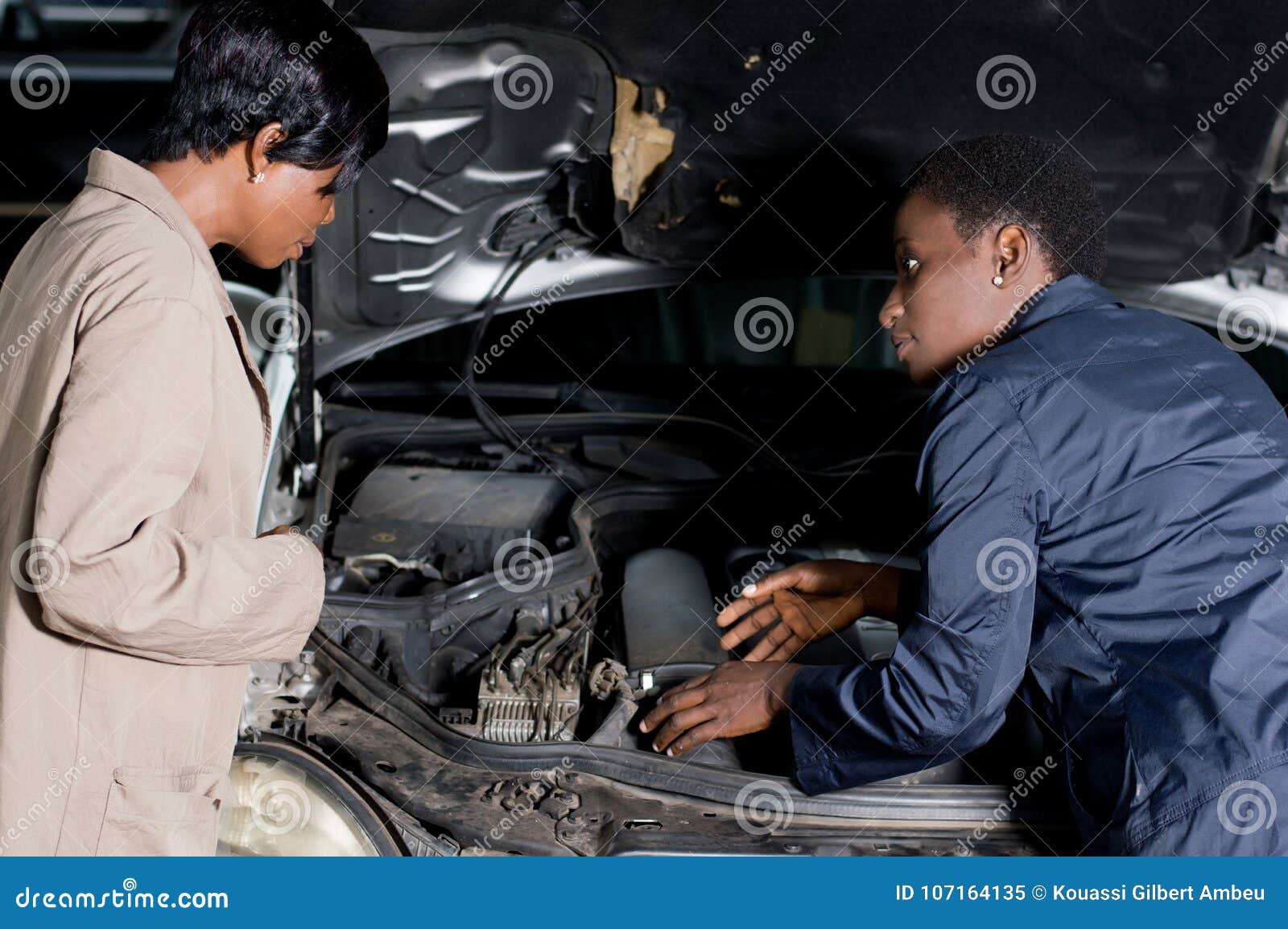 Mechanic and car owner. stock image. Image of female - 107164135