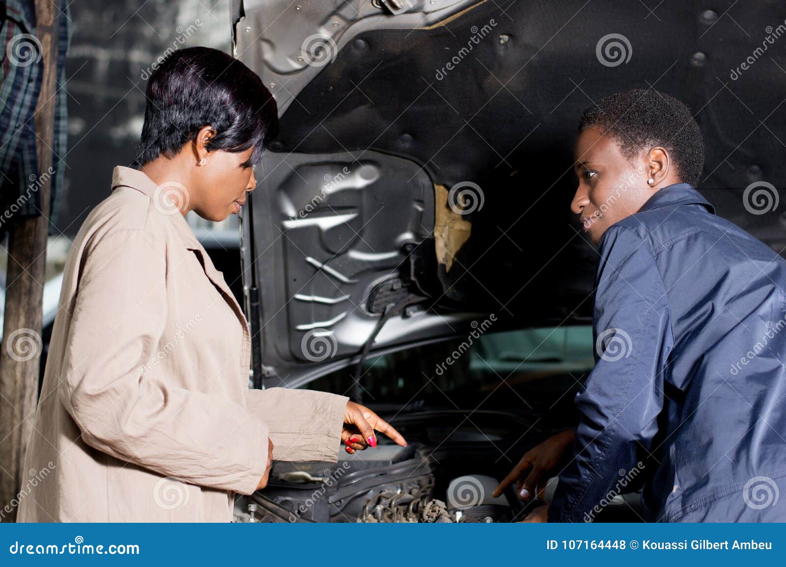 Mechanic and car owner. stock photo. Image of people - 107164448