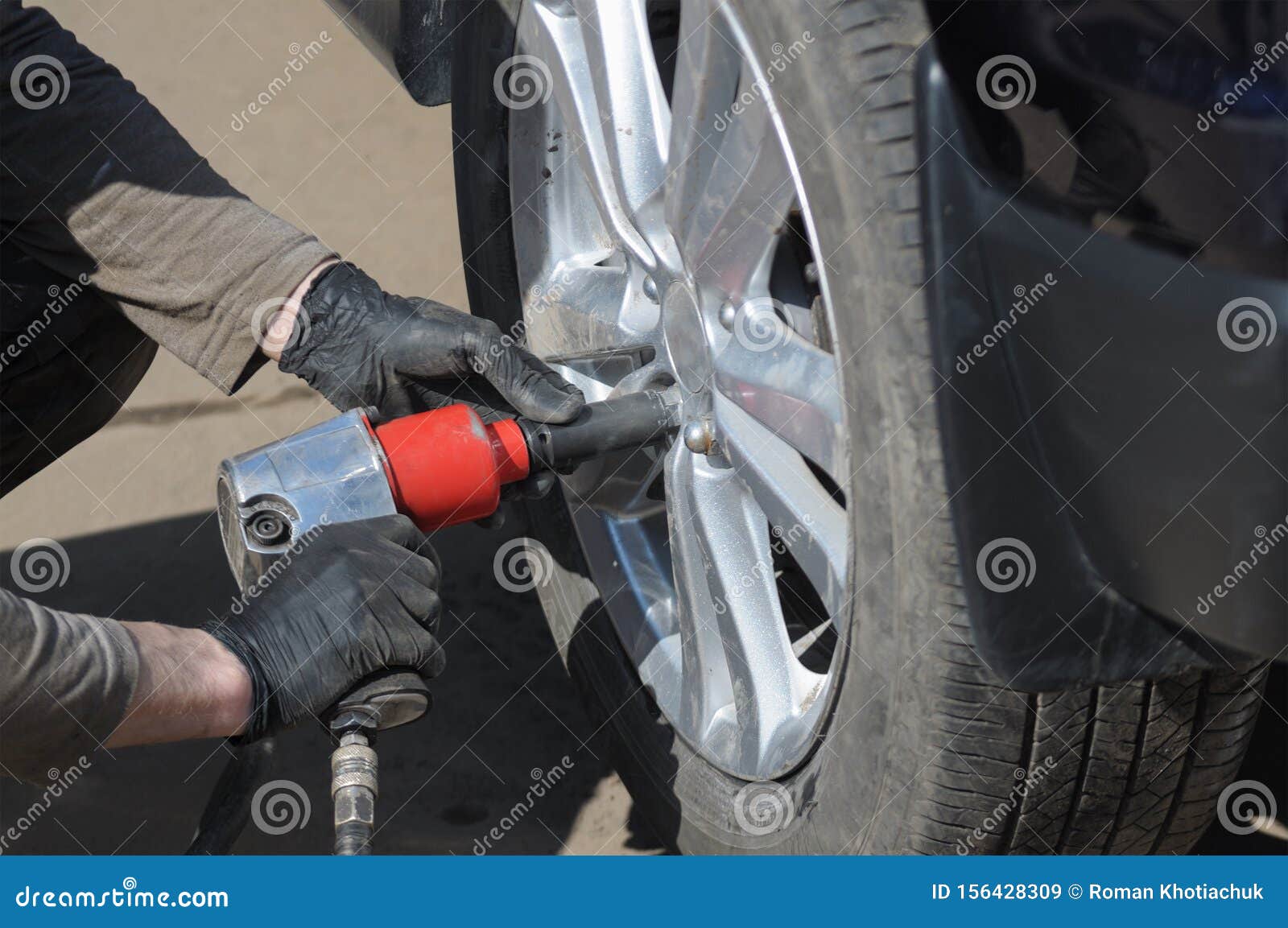 Mechanic Changes the Wheel on a Modern Car. Stock Image - Image of ...