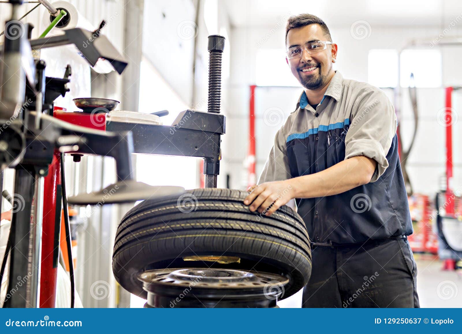 Mechanic Changing Car Tire at Work Stock Image - Image of holding, auto ...