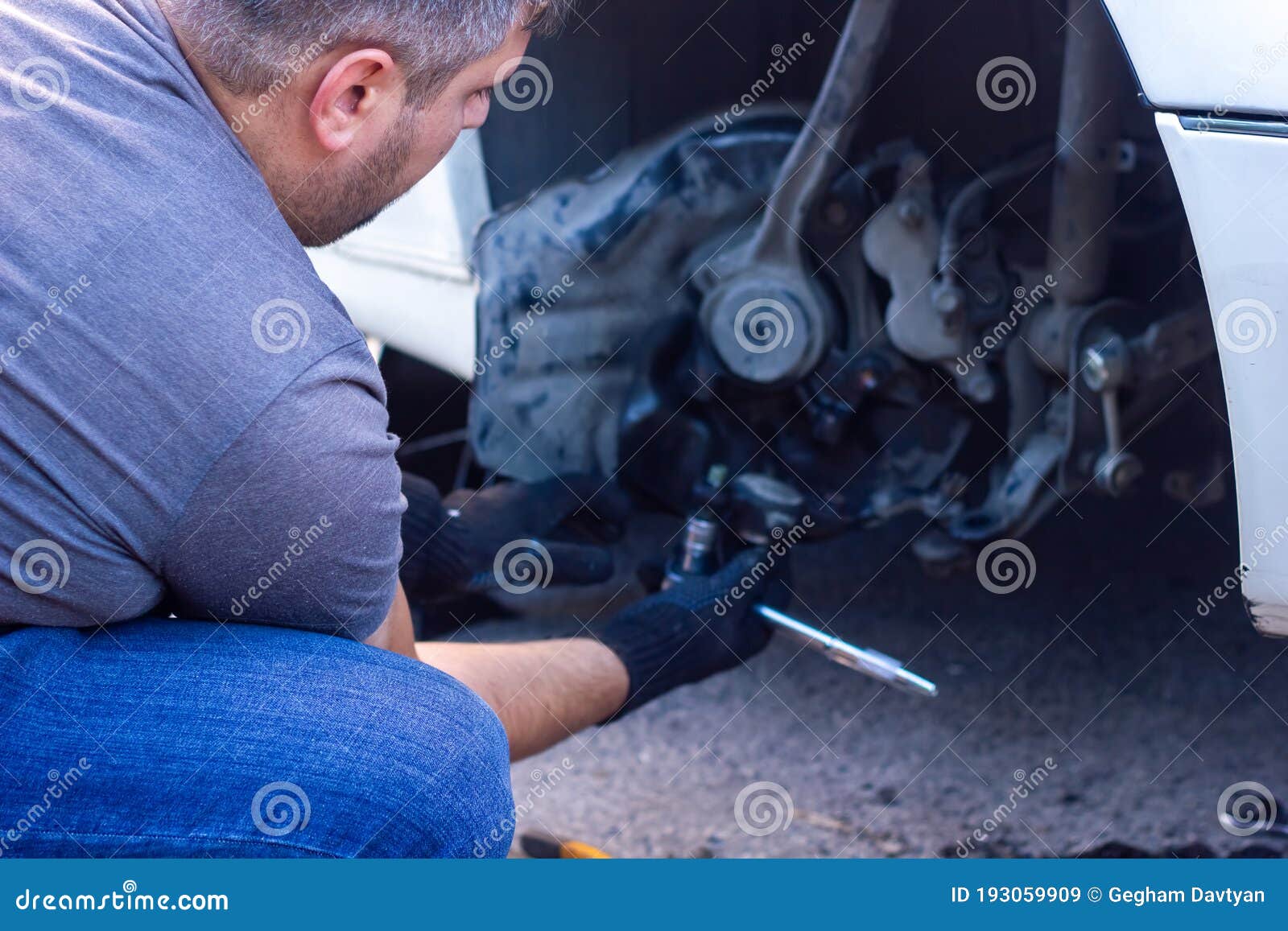 Mechanic Changing Car Wheel, Car Mechanic Changing the Wheel of a Car ...