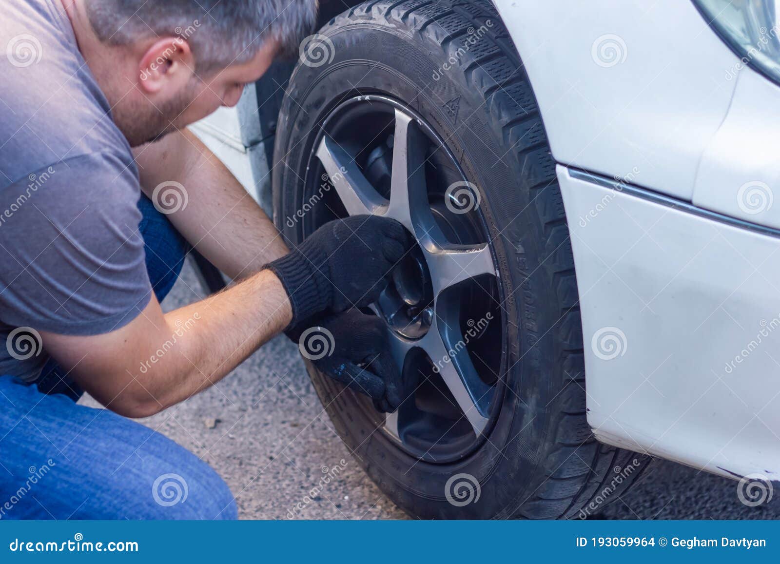 Mechanic Changing Car Wheel, Car Mechanic Changing the Wheel of a Car ...