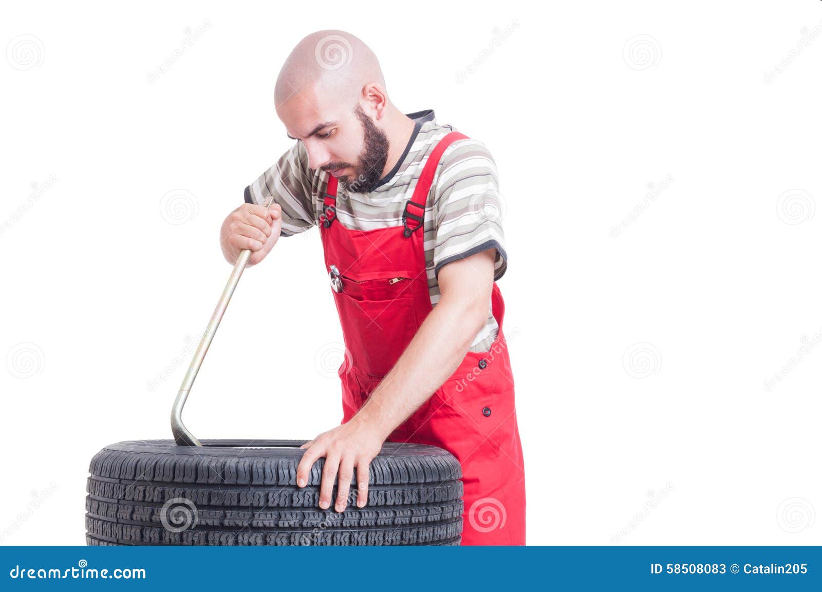 Mechanic Changing Tire Using Crowbar Stock Image - Image of mechanic ...