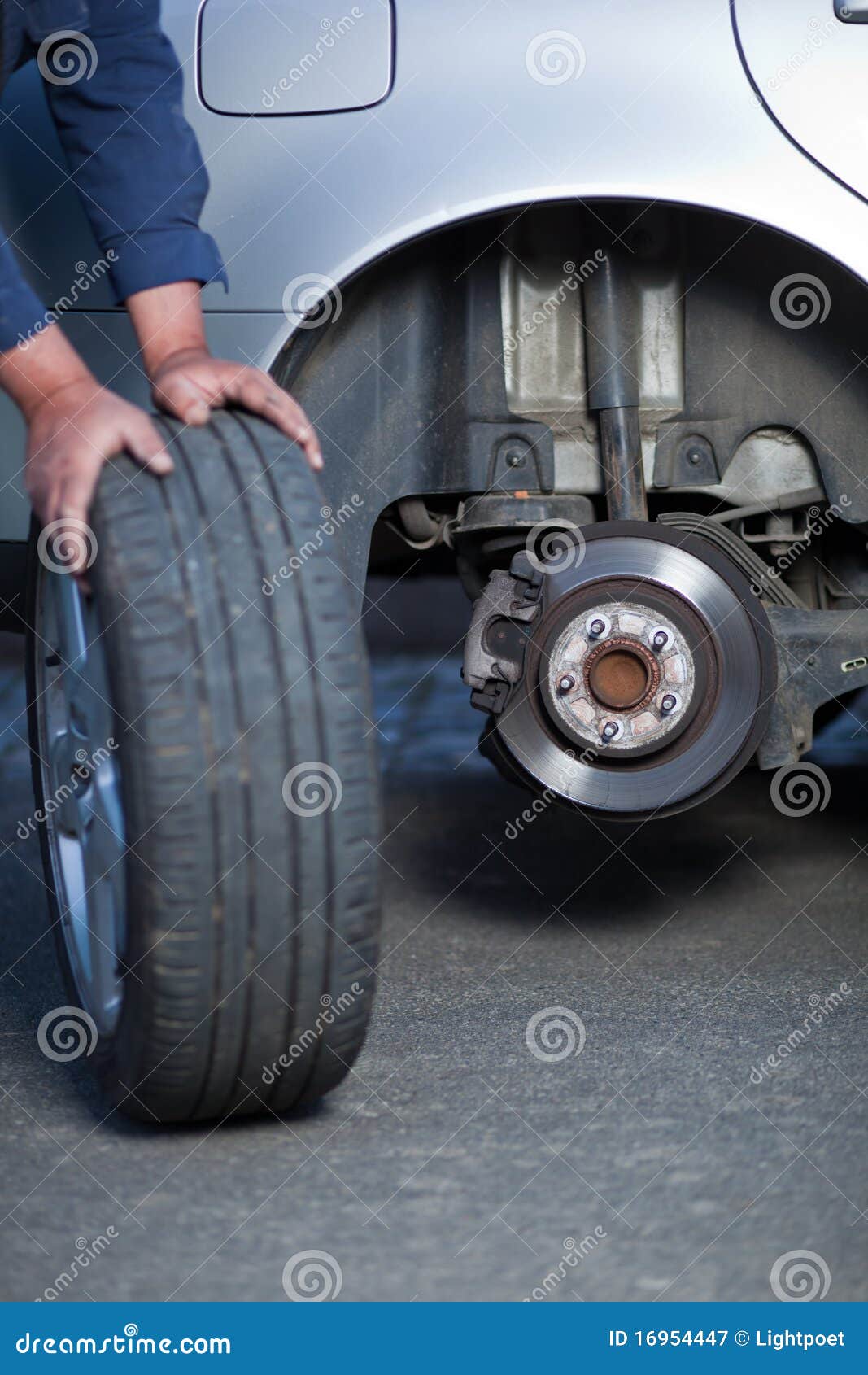 Mechanic changing a wheel stock image. Image of blue - 16954447