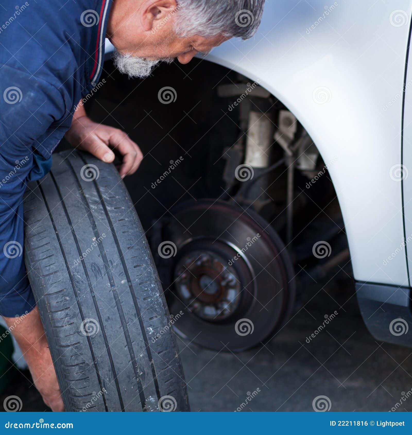Mechanic Changing a Wheel of a Modern Car Stock Photo - Image of ...