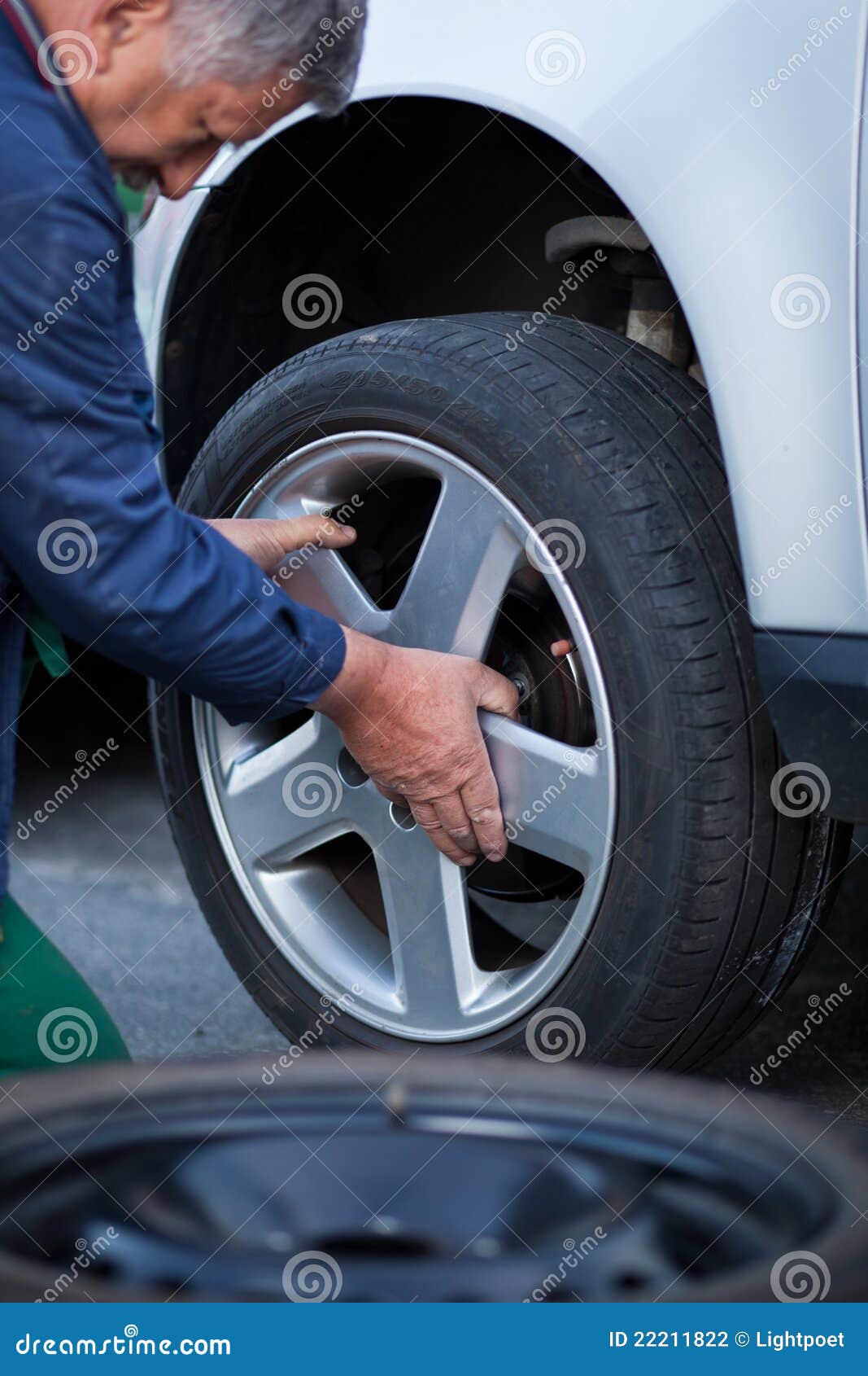Mechanic Changing a Wheel of a Modern Car Stock Photo - Image of person ...