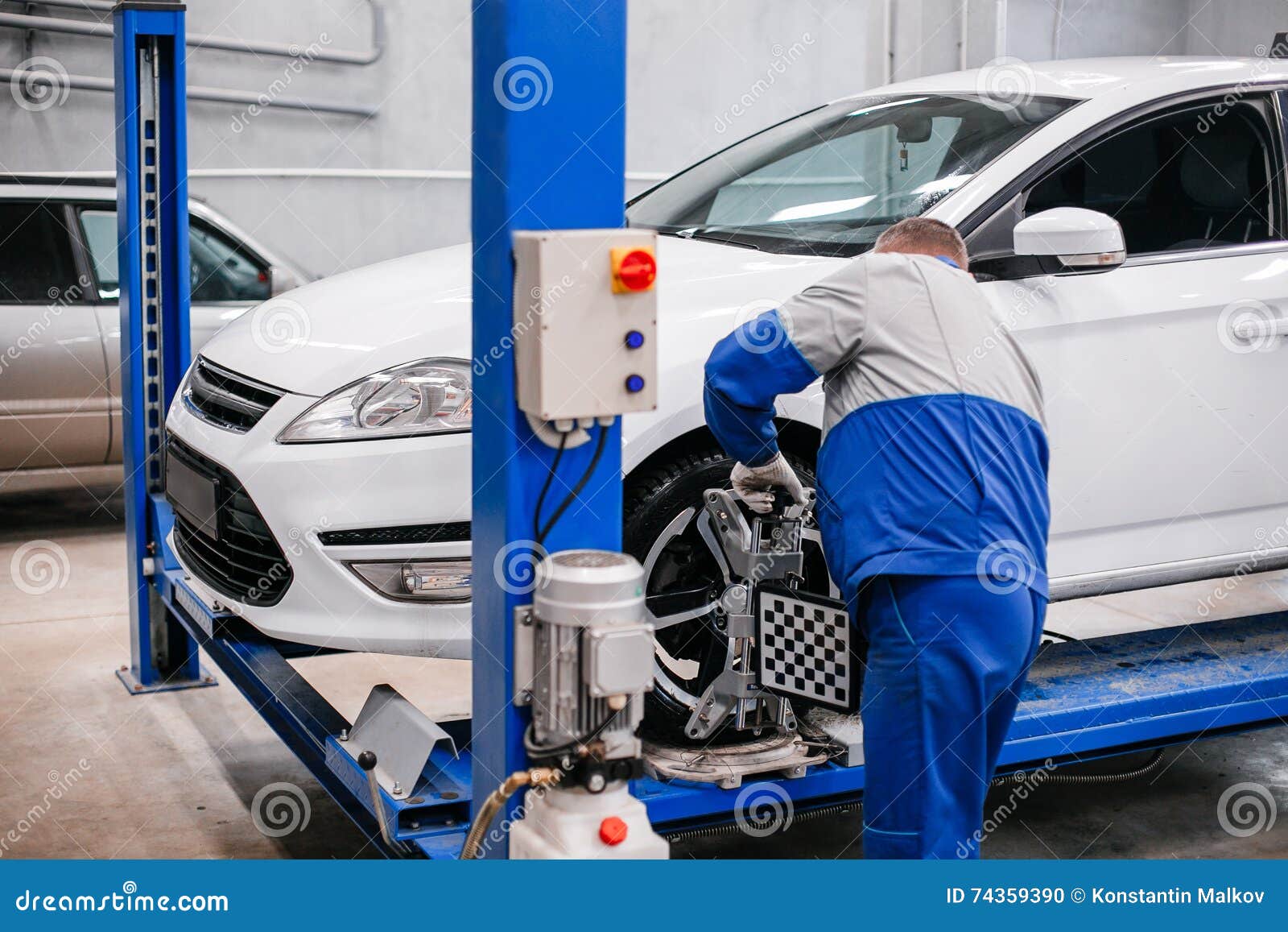 Mechanic Changing a Wheel of Modern Car in Workshop Stock Photo - Image ...