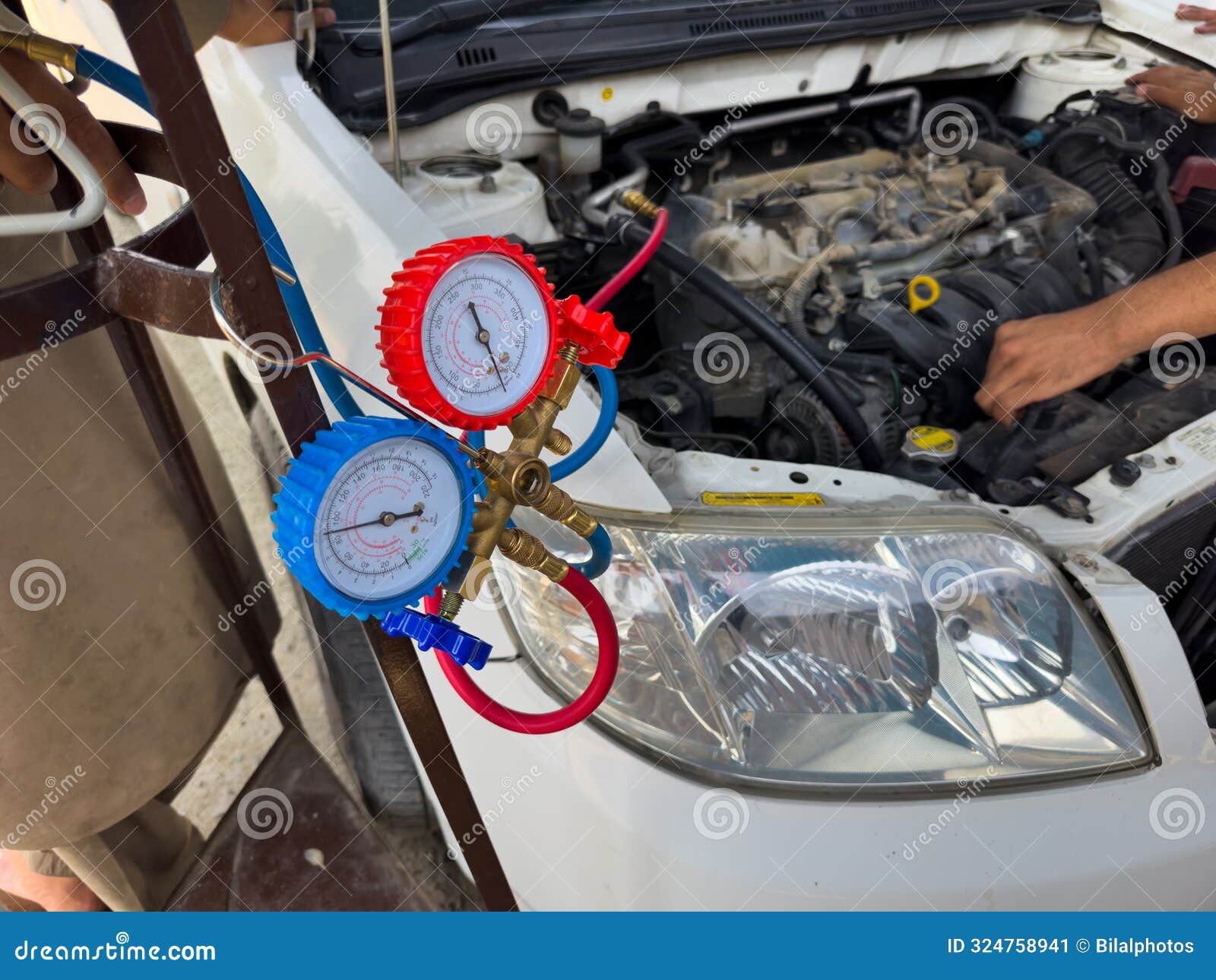Mechanic Checking Automotive AC Pressure Gauges with Tools Stock Image ...