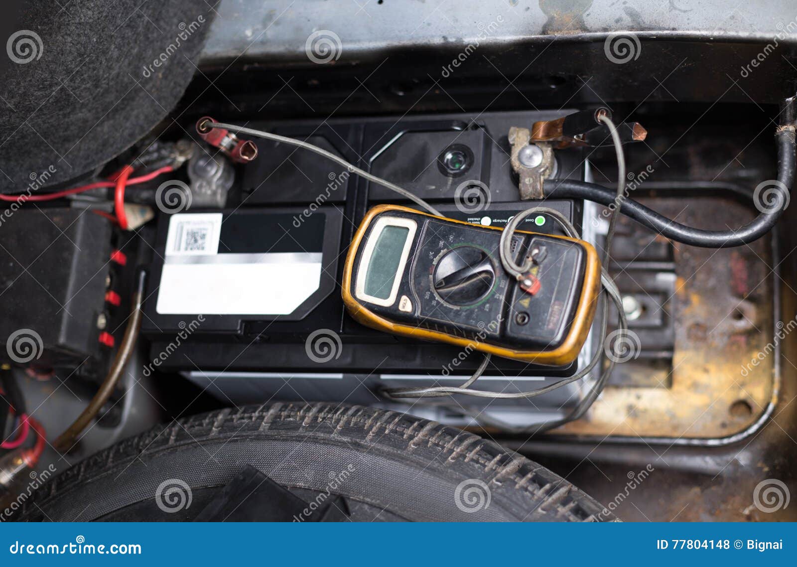 Mechanic Checking a Car Battery Level with Voltmeter Stock Photo ...
