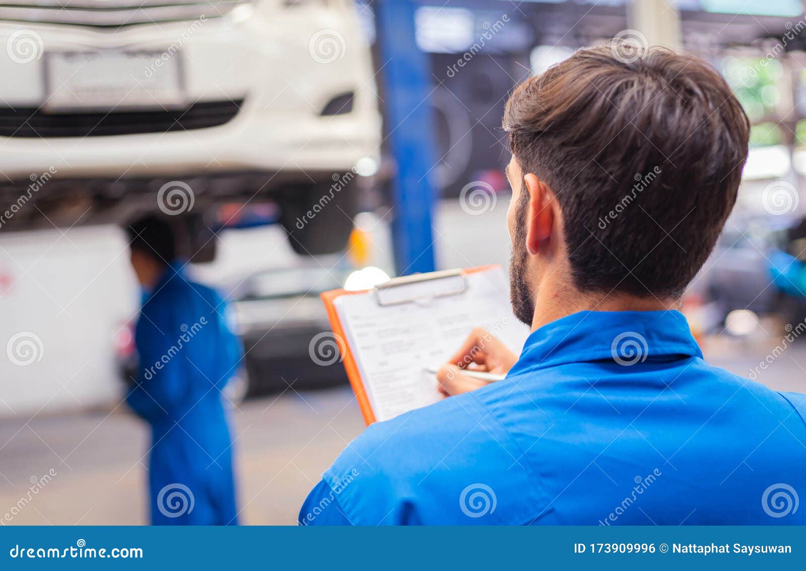 Mechanic Checking Car and Write Down in the Paper on Clipboard. Auto ...
