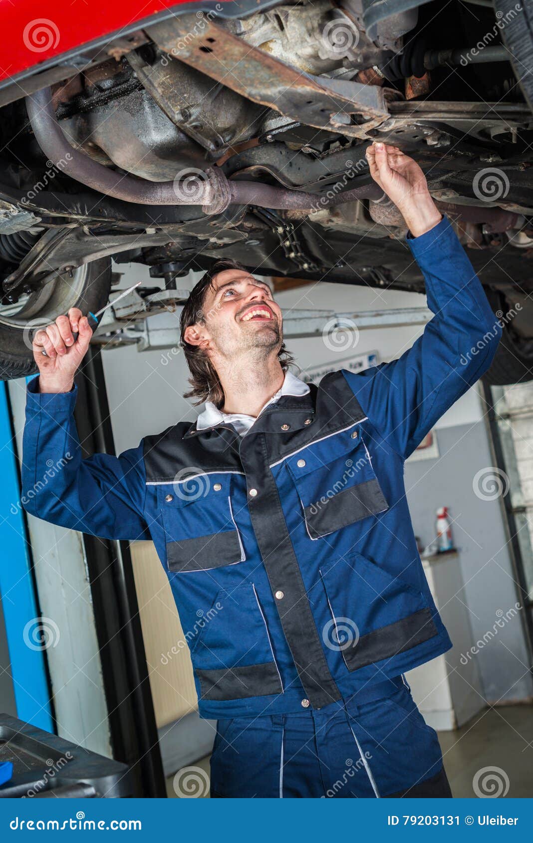 Mechanic Checking the Condition of a Lifted Car Stock Image - Image of ...