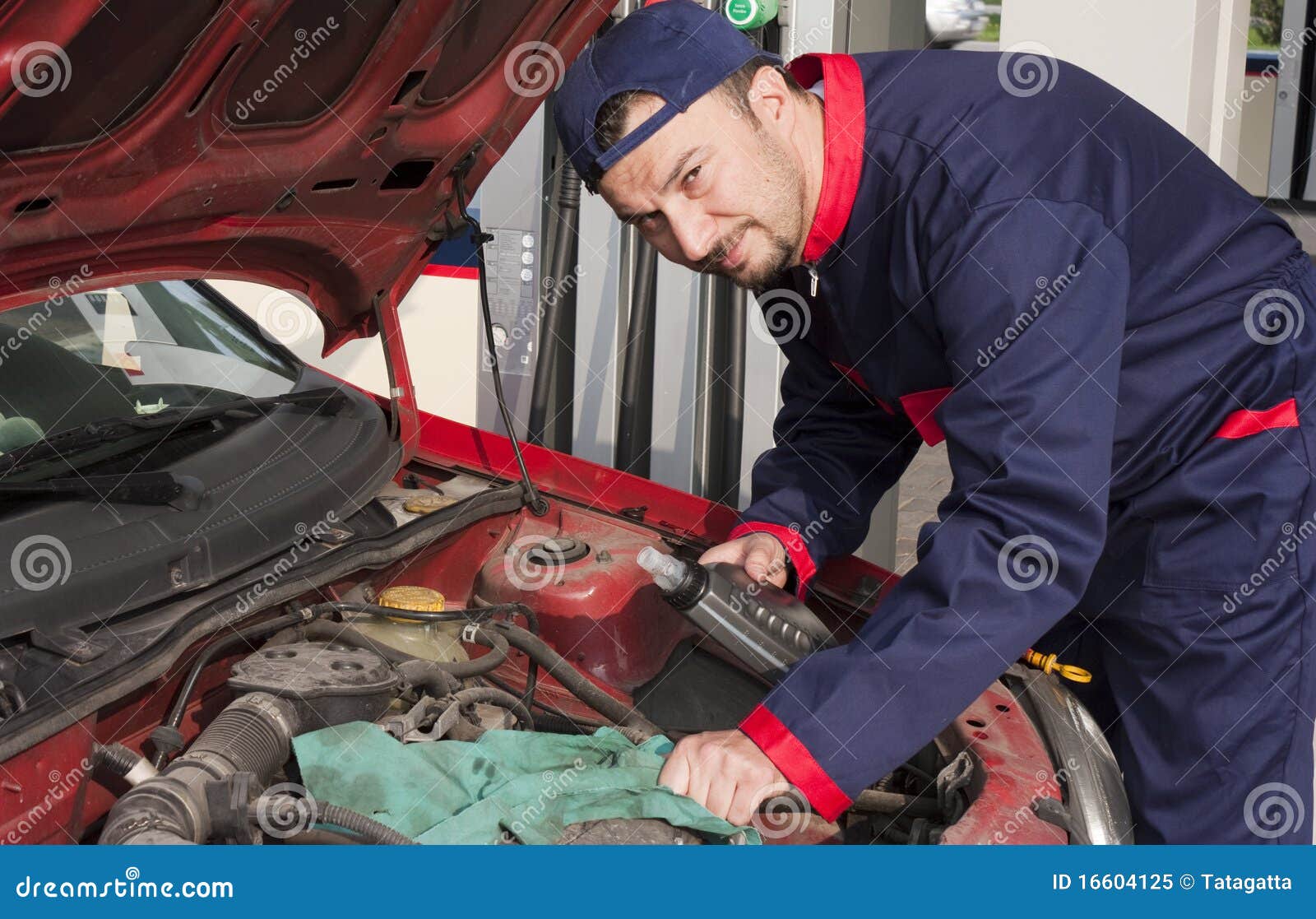 Mechanic Checking Oil Level In A Car Workshop. Man In Truck Service ...