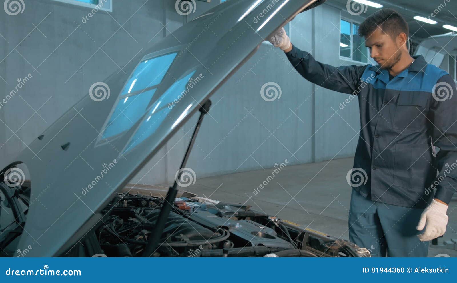 Mechanic Checking Oil Level in a Car Workshop. Man in Truck Service ...