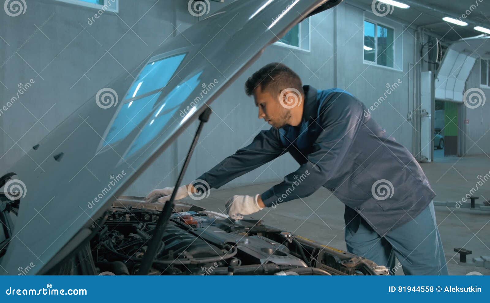 Mechanic Checking Oil Level in a Car Workshop. Man in Truck Service ...