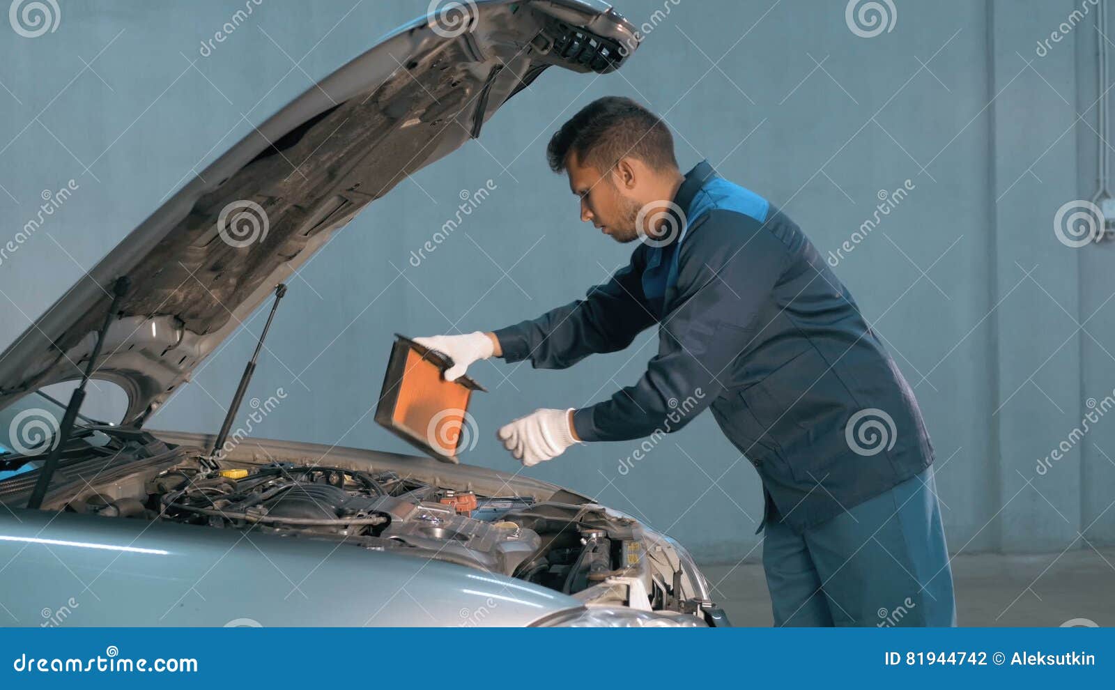Mechanic Checking Oil Level in a Car Workshop. Man in Truck Service ...