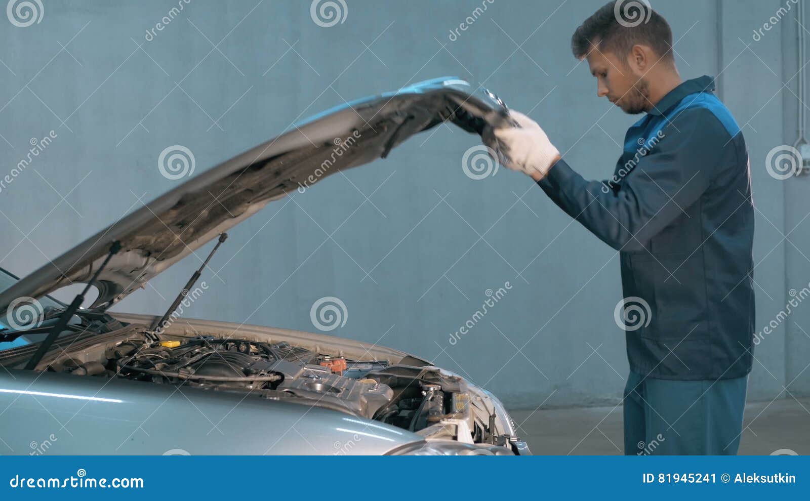 Mechanic Checking Oil Level in a Car Workshop. Man in Truck Service ...