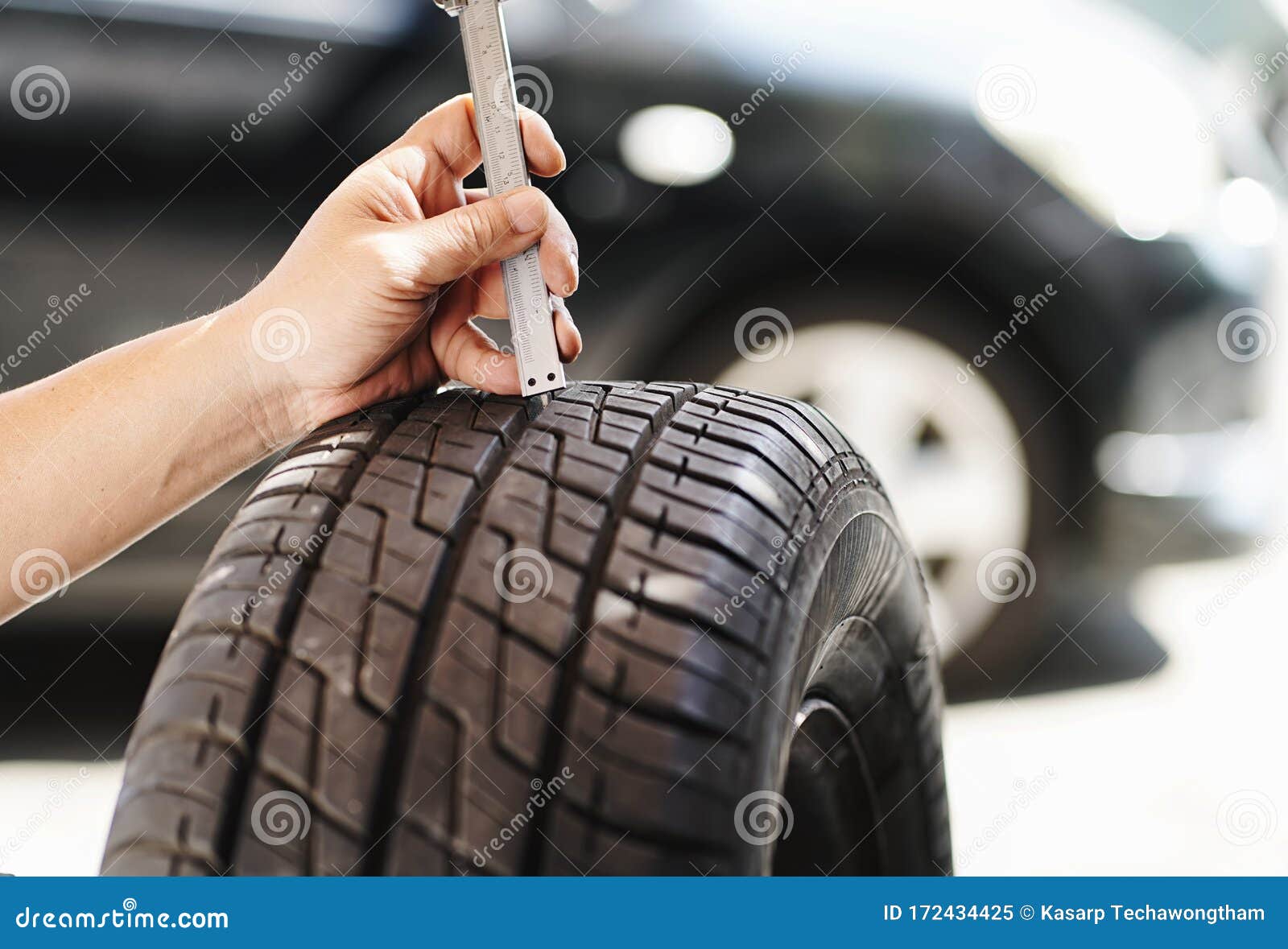 Mechanic Checking Tire Tread Measurements with Calipers Tool Stock ...